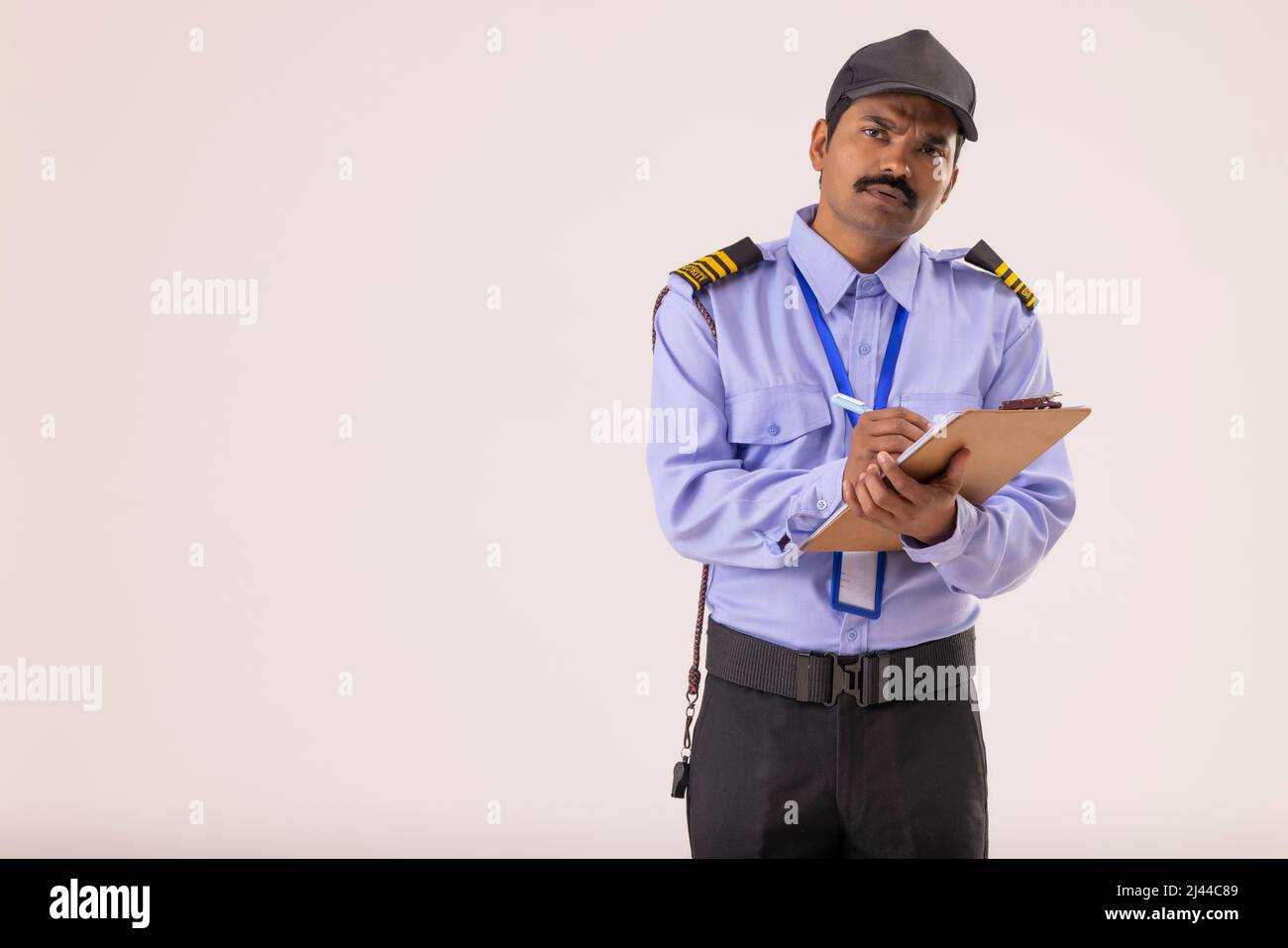 Portrait of a male security guard writing on clipboard Stock Photo - Alamy