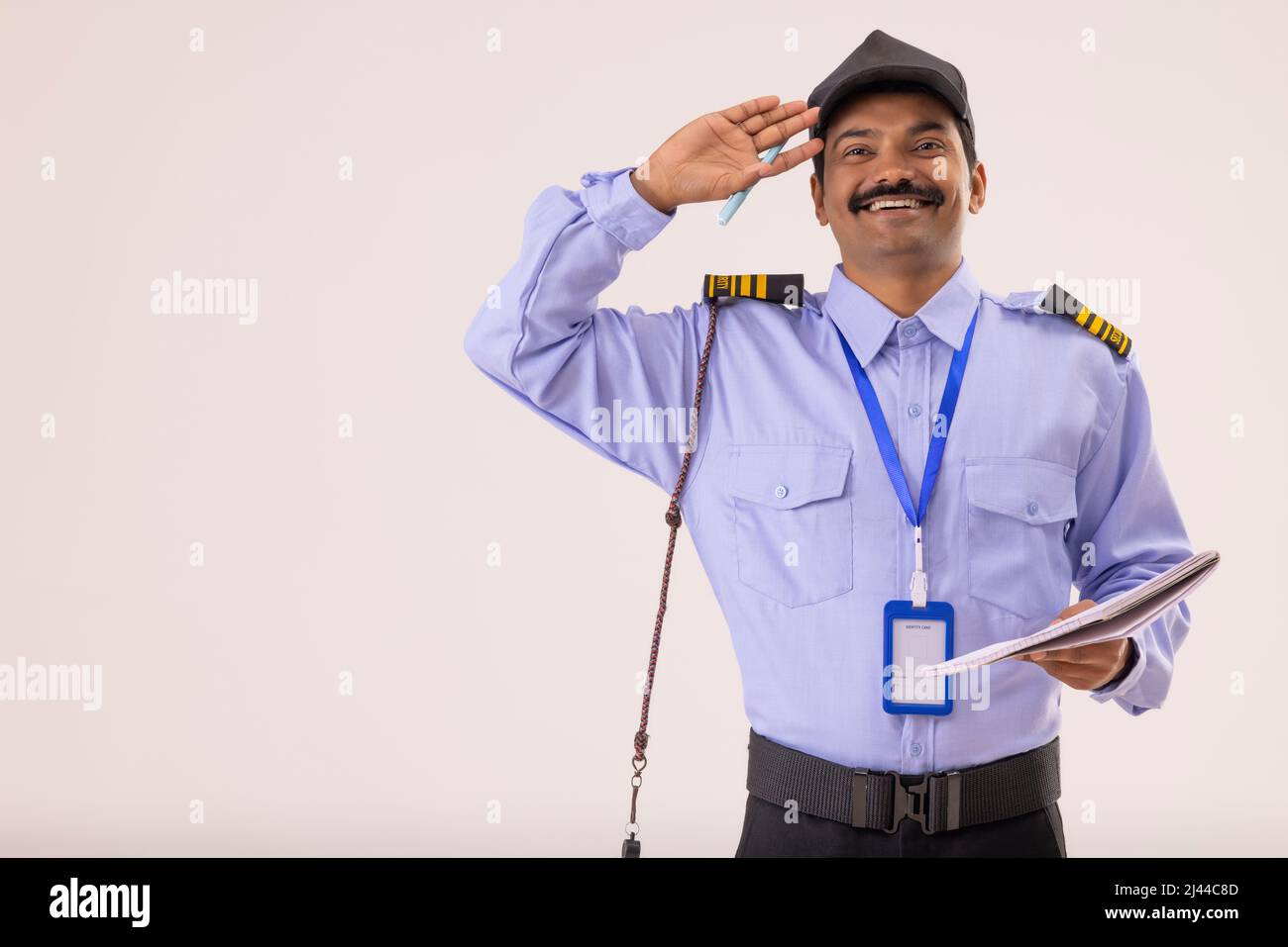 Portrait of a male security guard saluting Stock Photo - Alamy