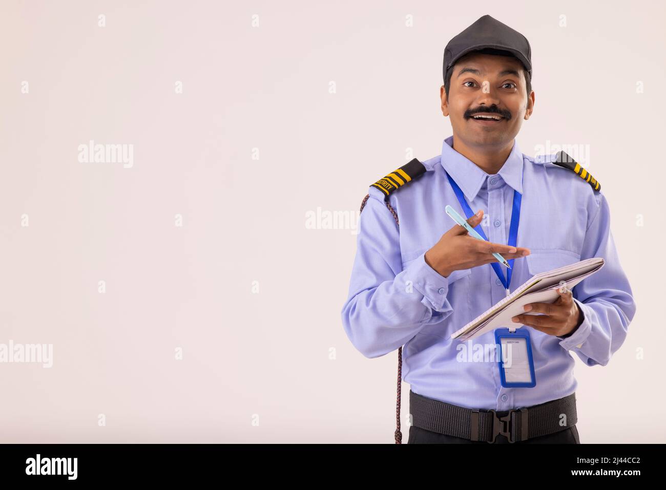 Portrait of security guard pointing at notebook Stock Photo - Alamy