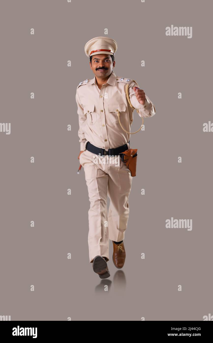 Portrait of an Indian policeman running Stock Photo - Alamy