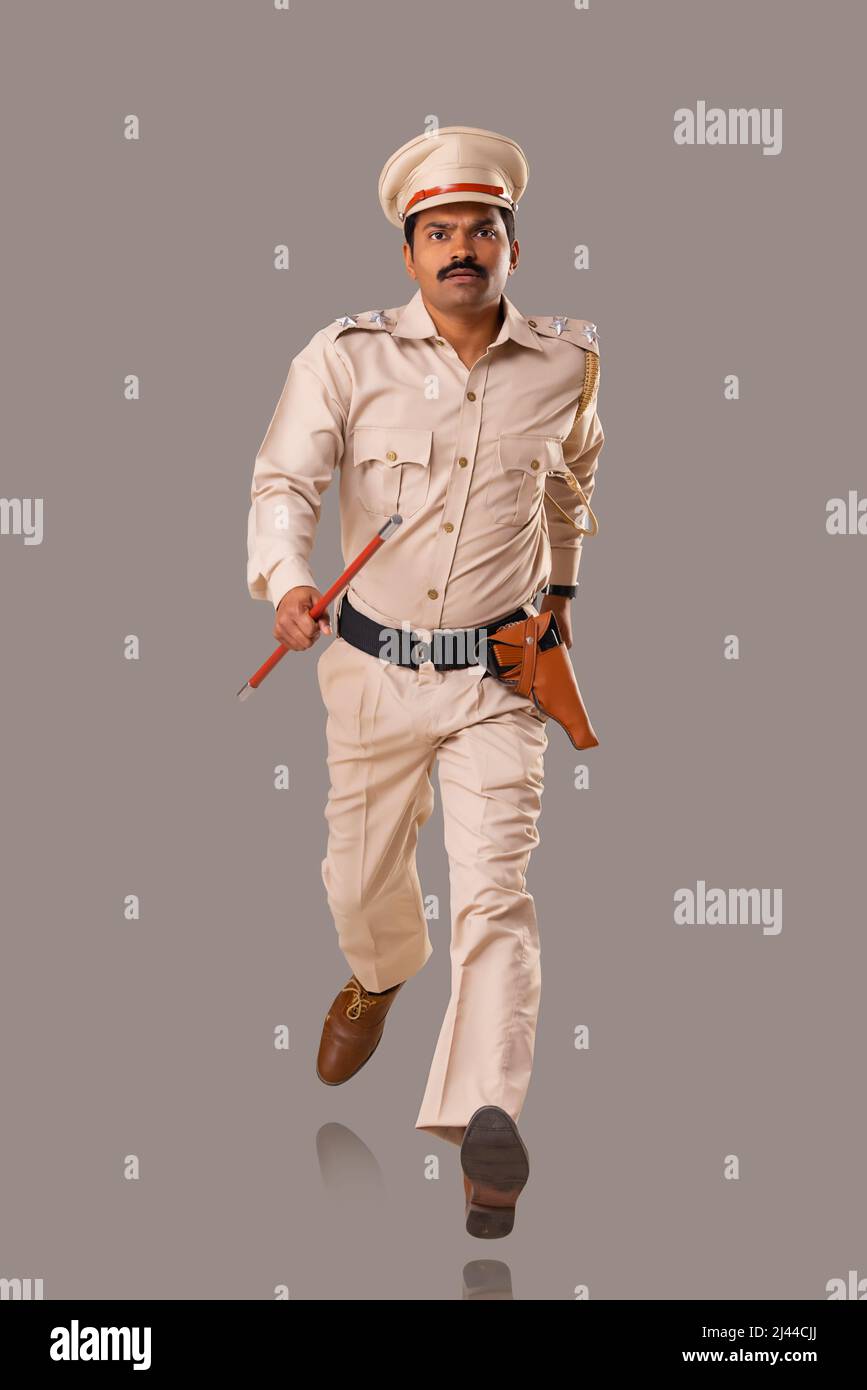 Portrait of an Indian policeman running Stock Photo - Alamy
