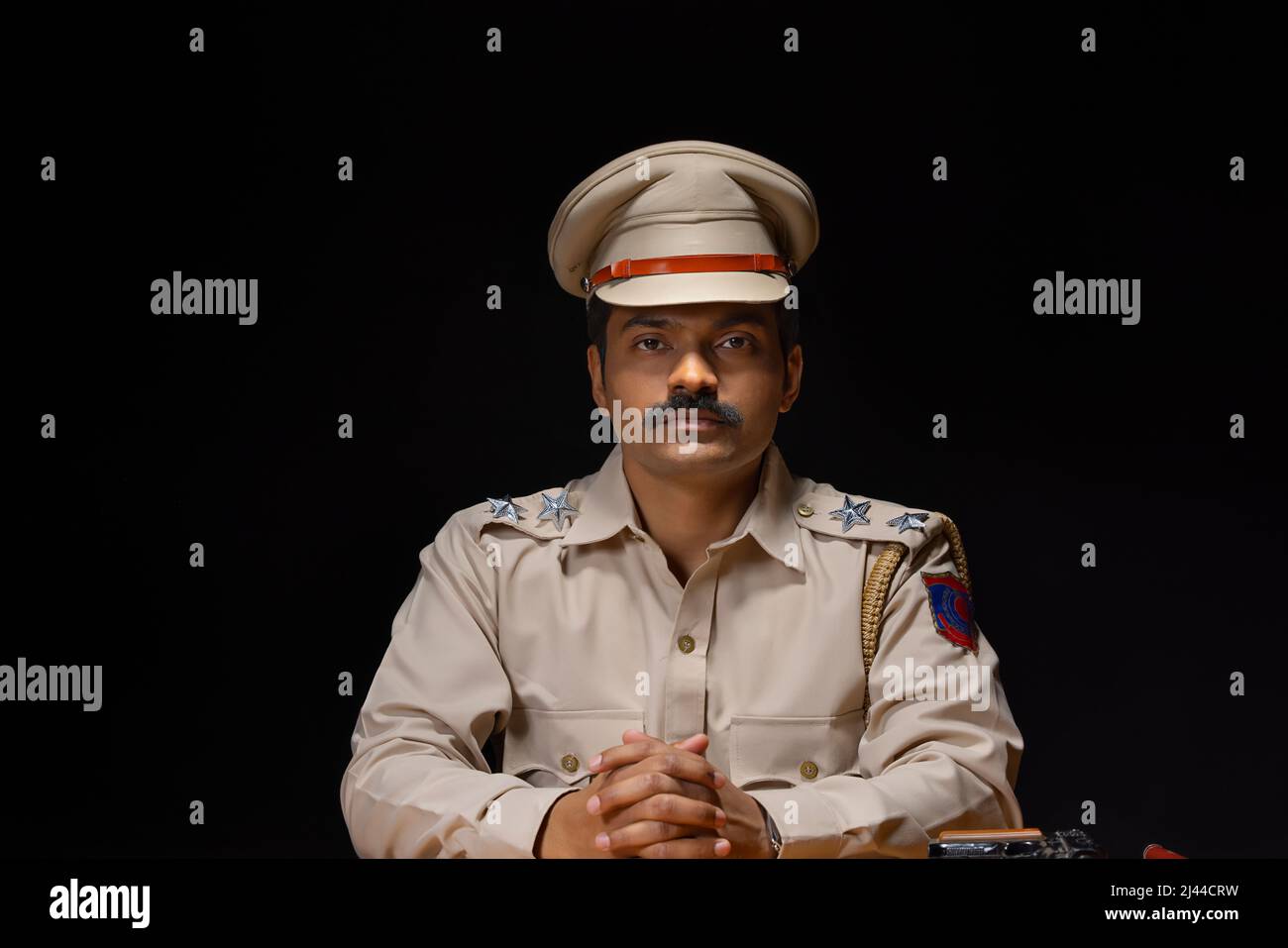 Portrait of an Indian policeman sitting in policestation Stock Photo ...