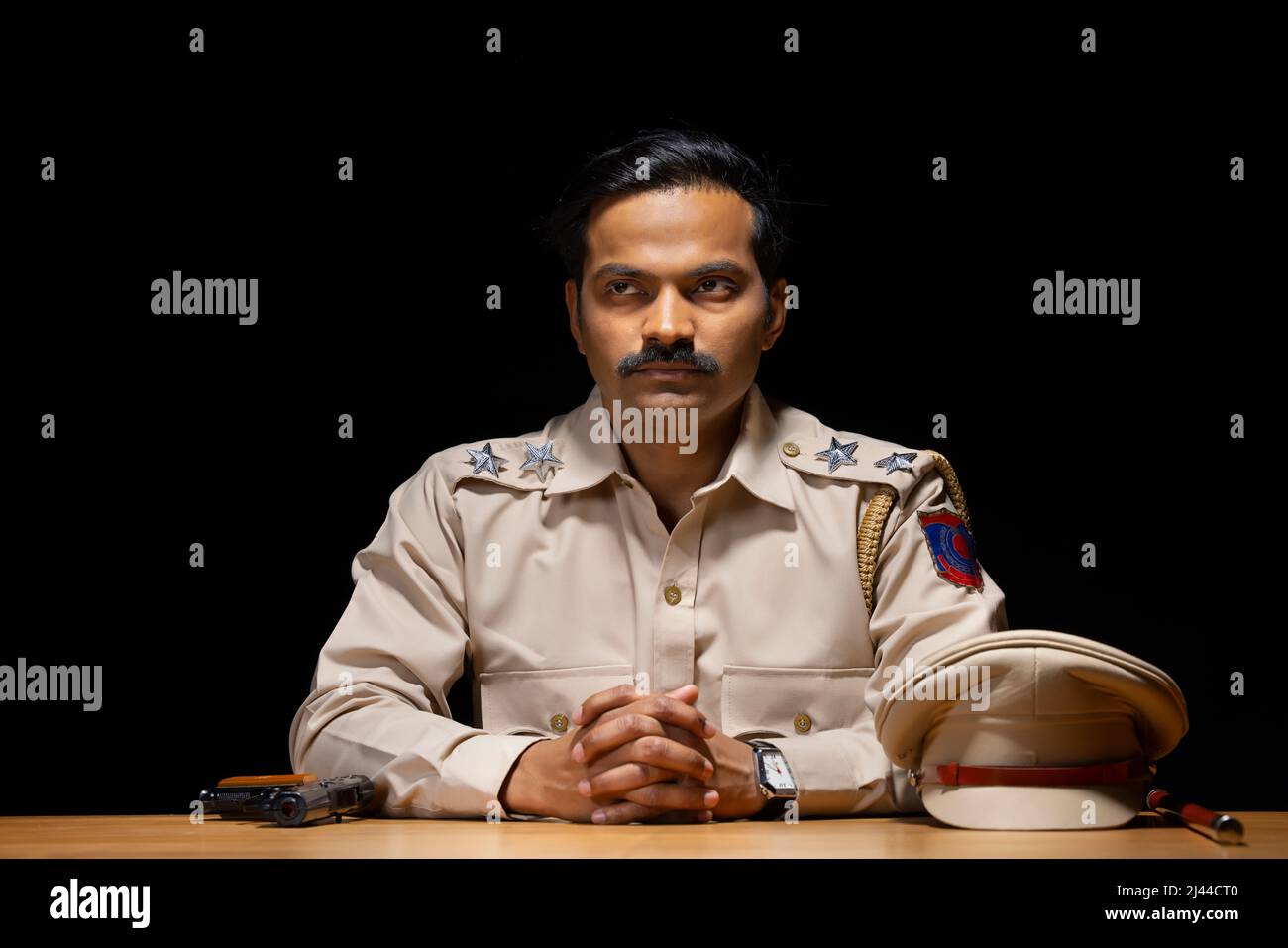 Portrait of an Indian policeman sitting in policestation Stock Photo ...