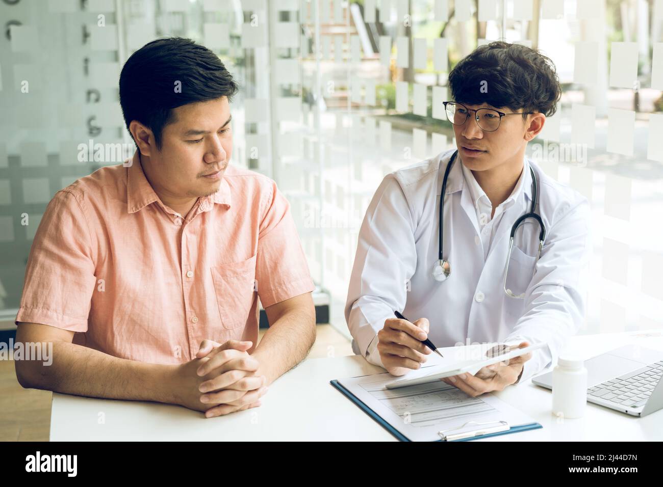 Asian doctor is examining the abnormal items of the body and diagnosing ...