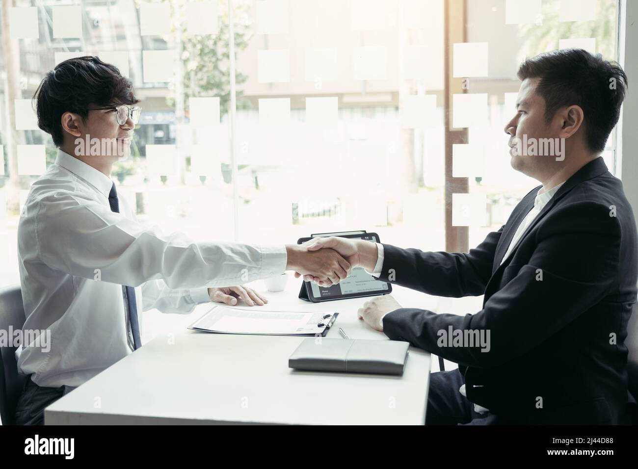Manager and employee interview concept with handshake after talking ...