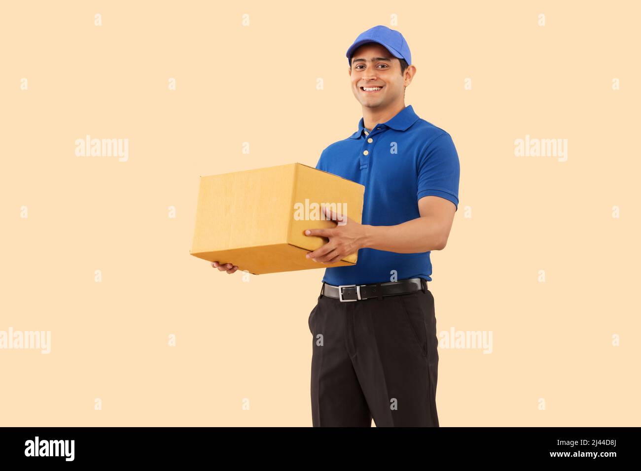 Portrait of a courier delivery boy with cardboard box in hand Stock ...
