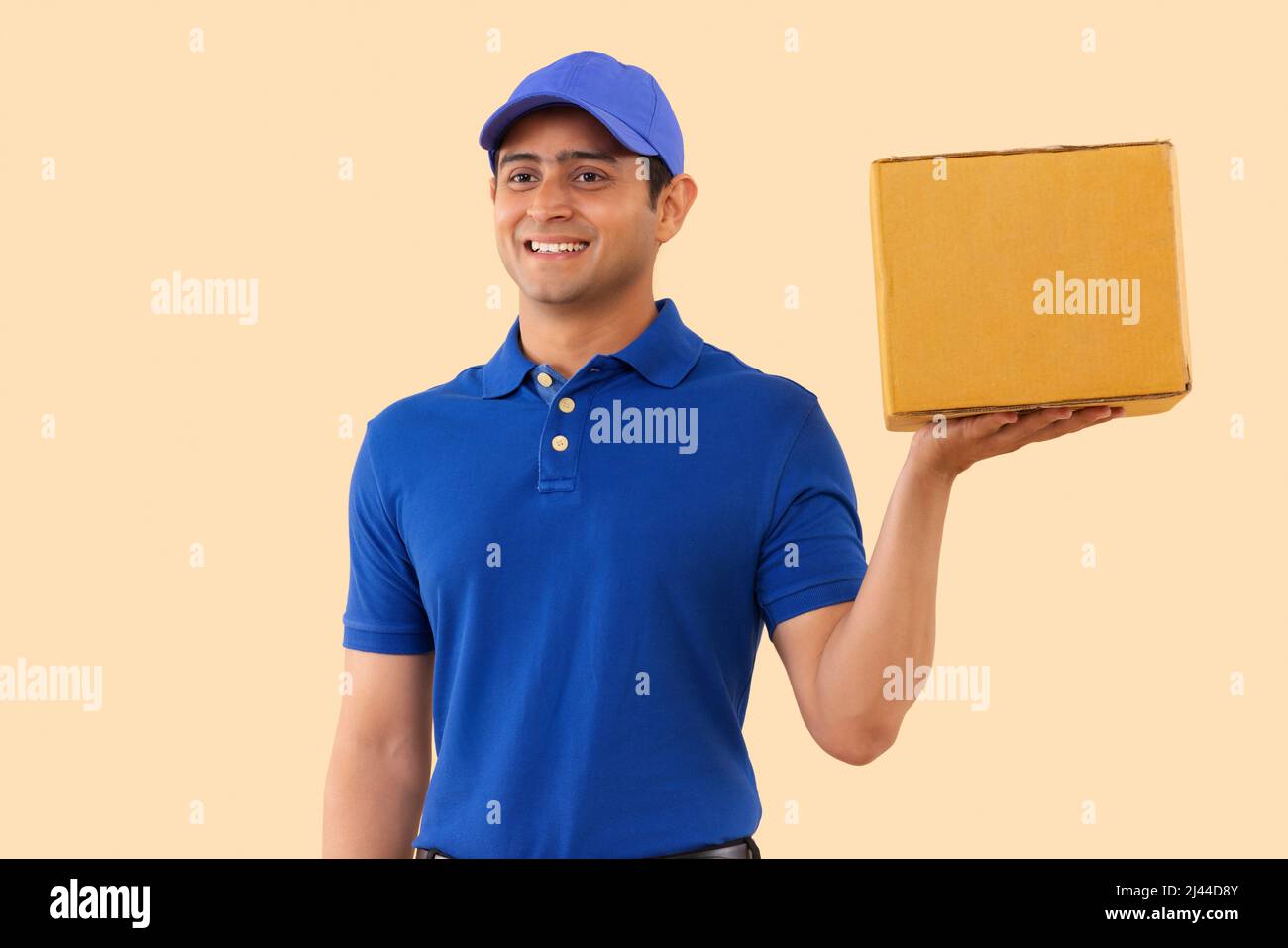 Portrait of a courier delivery boy with cardboard box on his palm Stock ...