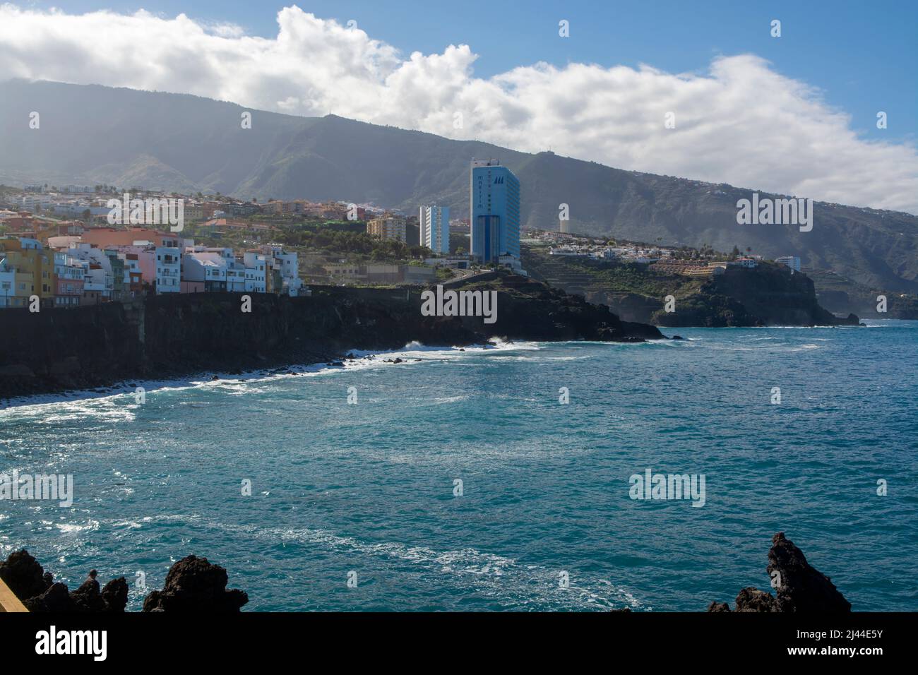 View on colorful houses and black lava rocks in small fisherman village ...