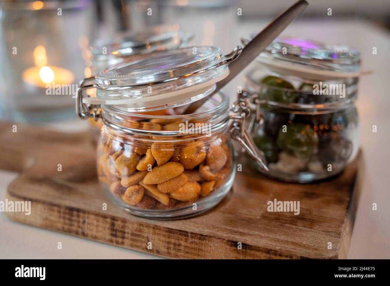 Glass jars with healthy party snacks served in bar, tasty appetisers ...