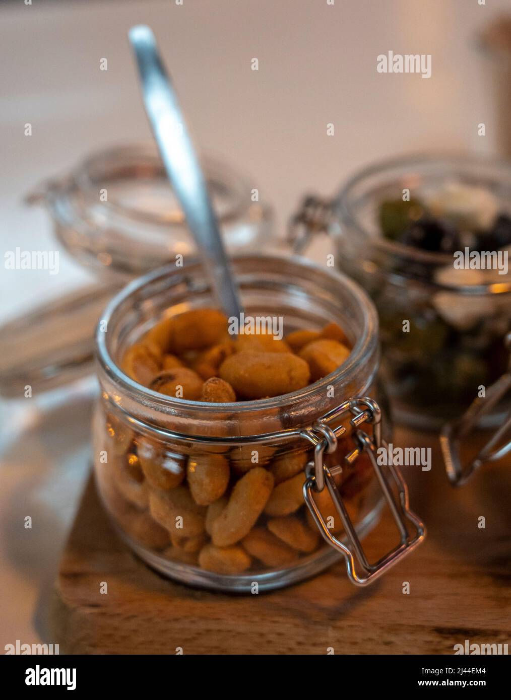 Glass jars with healthy party snacks served in bar, tasty appetisers ...