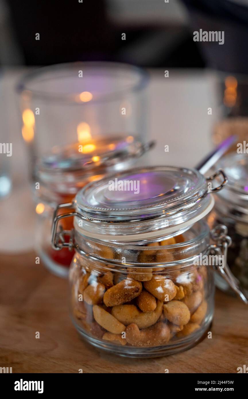 Glass jars with healthy party snacks served in bar, tasty appetisers ...