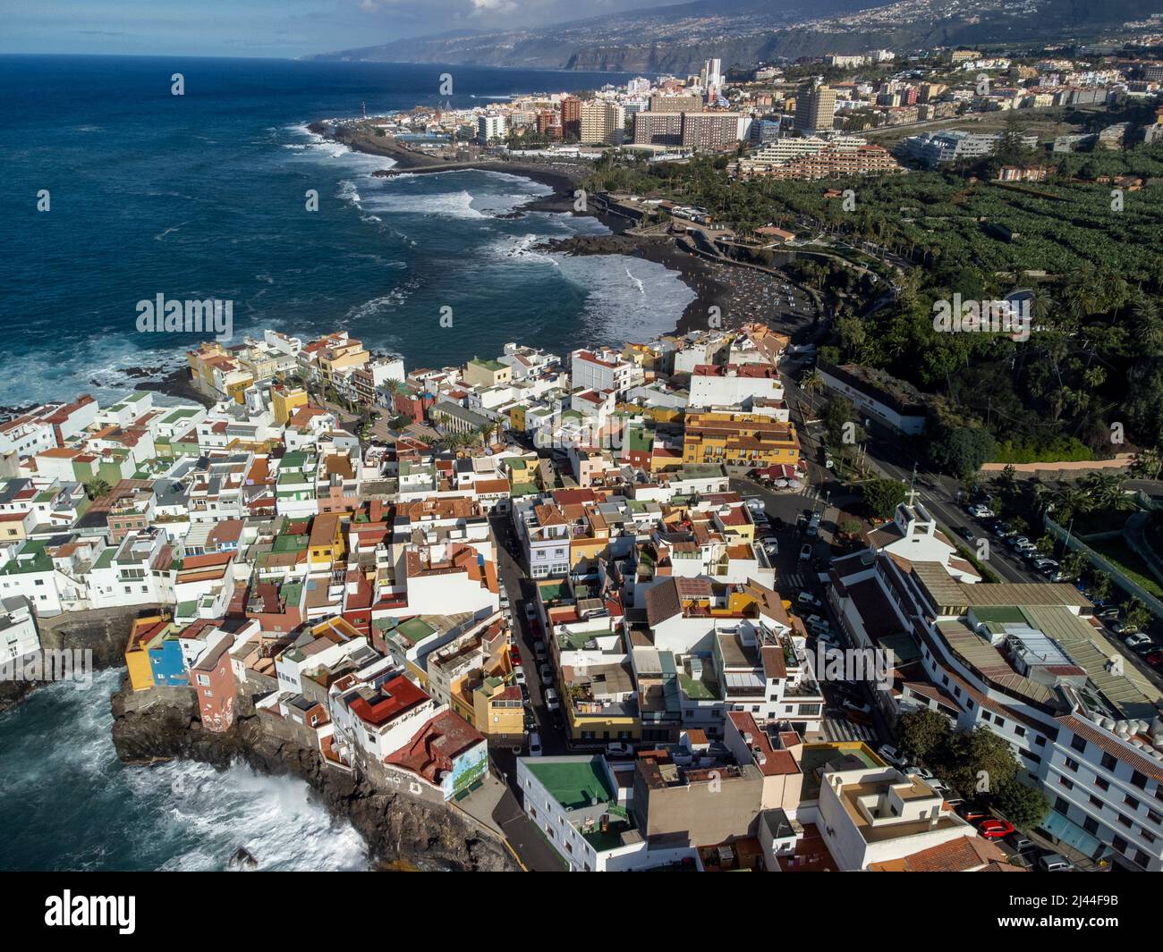 Aerial view on colorful houses and black lava rocks in small fisherman ...