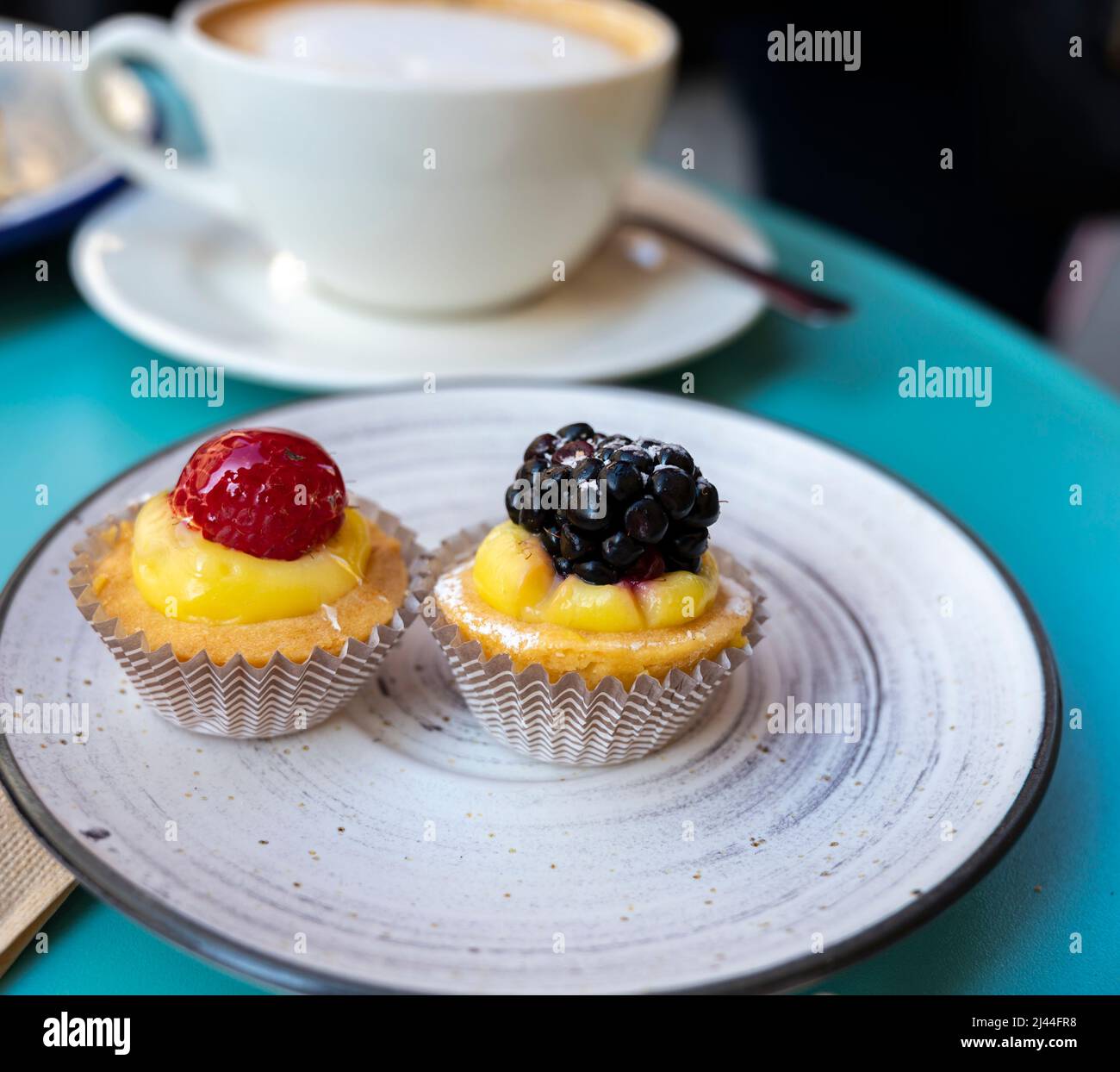 Two mini fruit italian cupcakes with fresh berries on board Stock Photo ...