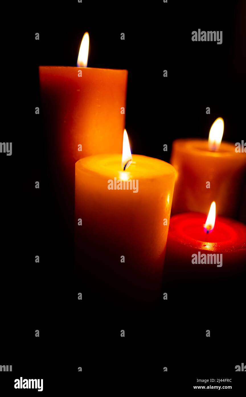 Burning red candles on black background copy space Stock Photo - Alamy