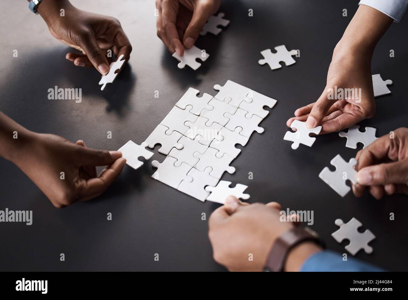 Problem solving as a dedicated team should. Closeup shot of a group of ...