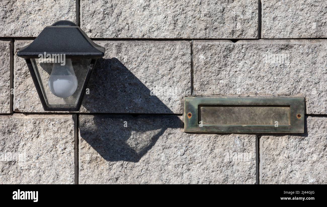 Mailbox hatch and light bulb. Block wall or fence Stock Photo - Alamy