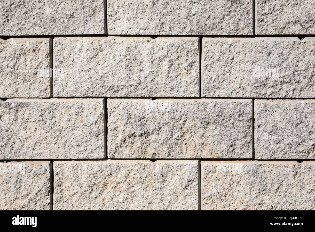 Facade finishing stone blocks. Gray brick background Stock Photo - Alamy