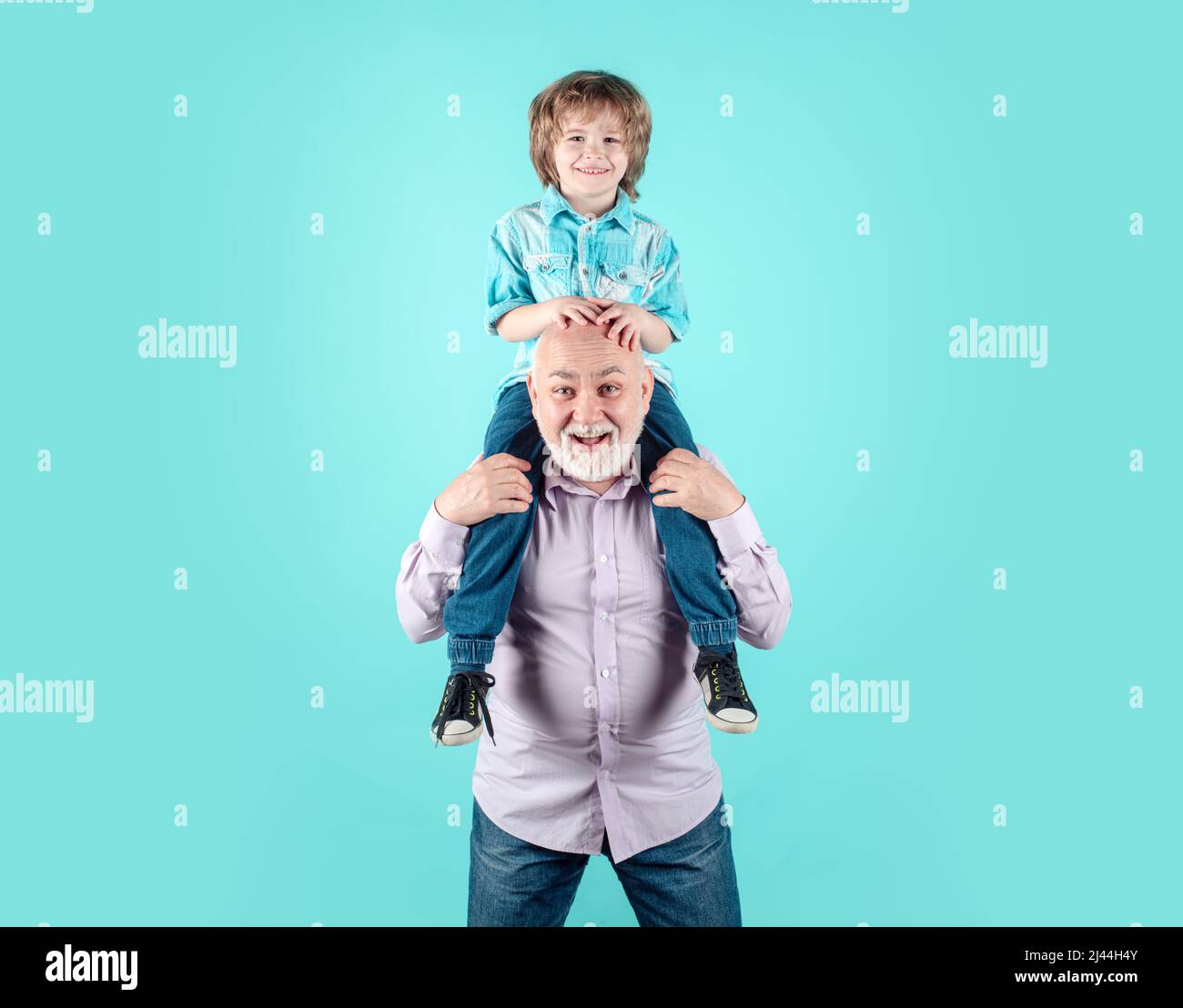 Old grandfather and young child grandson piggyback with funny face ...