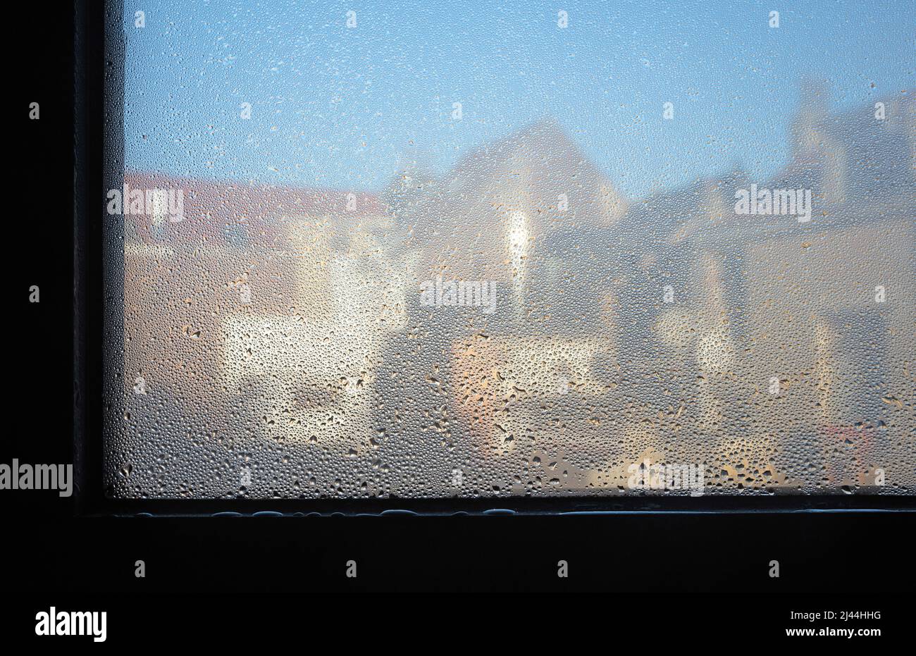 Waterdrops on the glass, close-up of window surface, city background ...