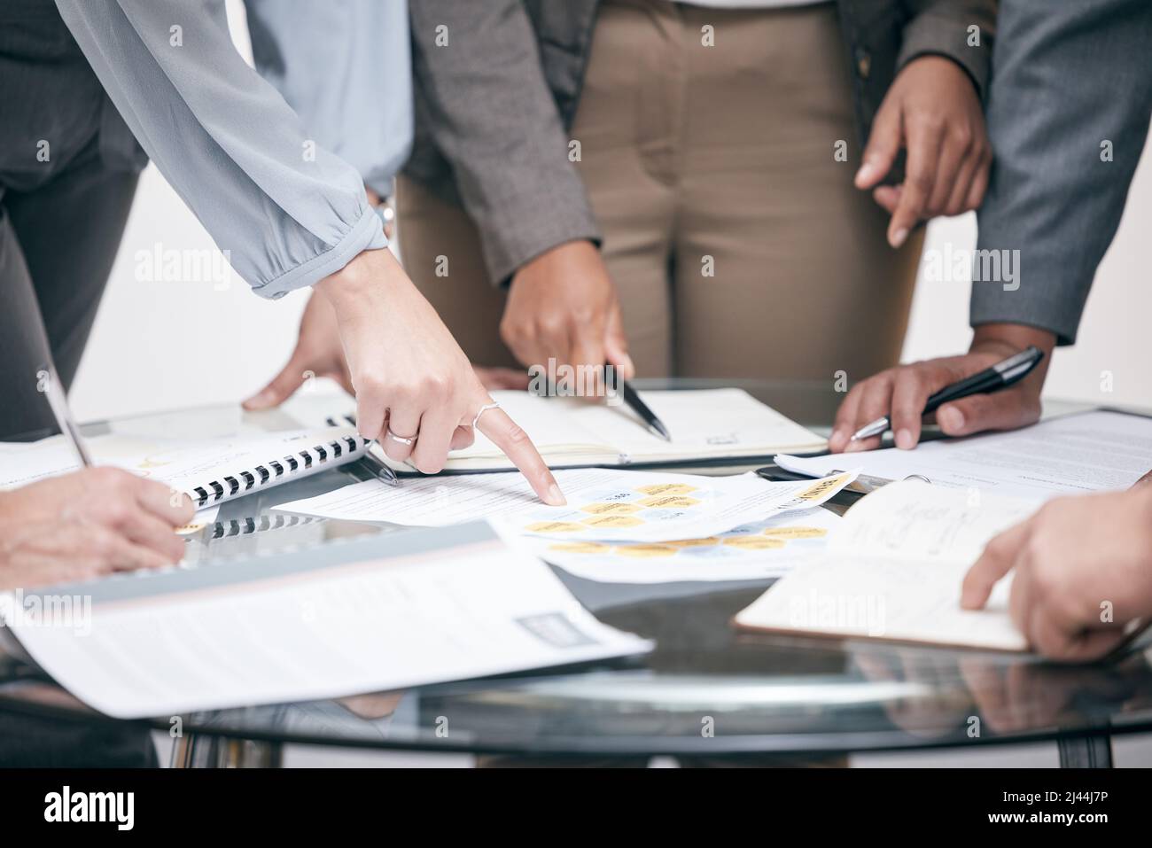 Going over the facts and figures. Cropped shot of a group of ...