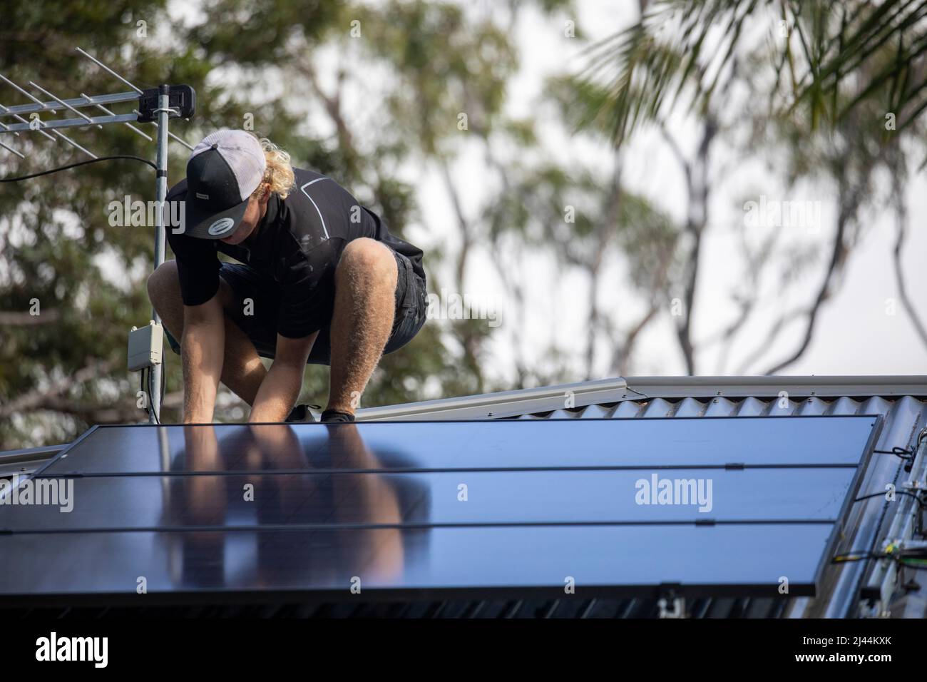 Man installing solar PV roof panel on the roof of a house in Sydney,NSW ...