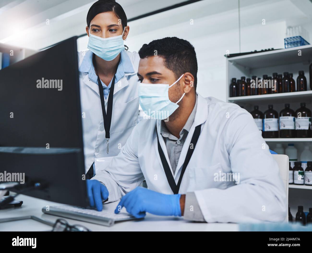 Two serious researchers using a computer in the laboratory Stock Photo ...
