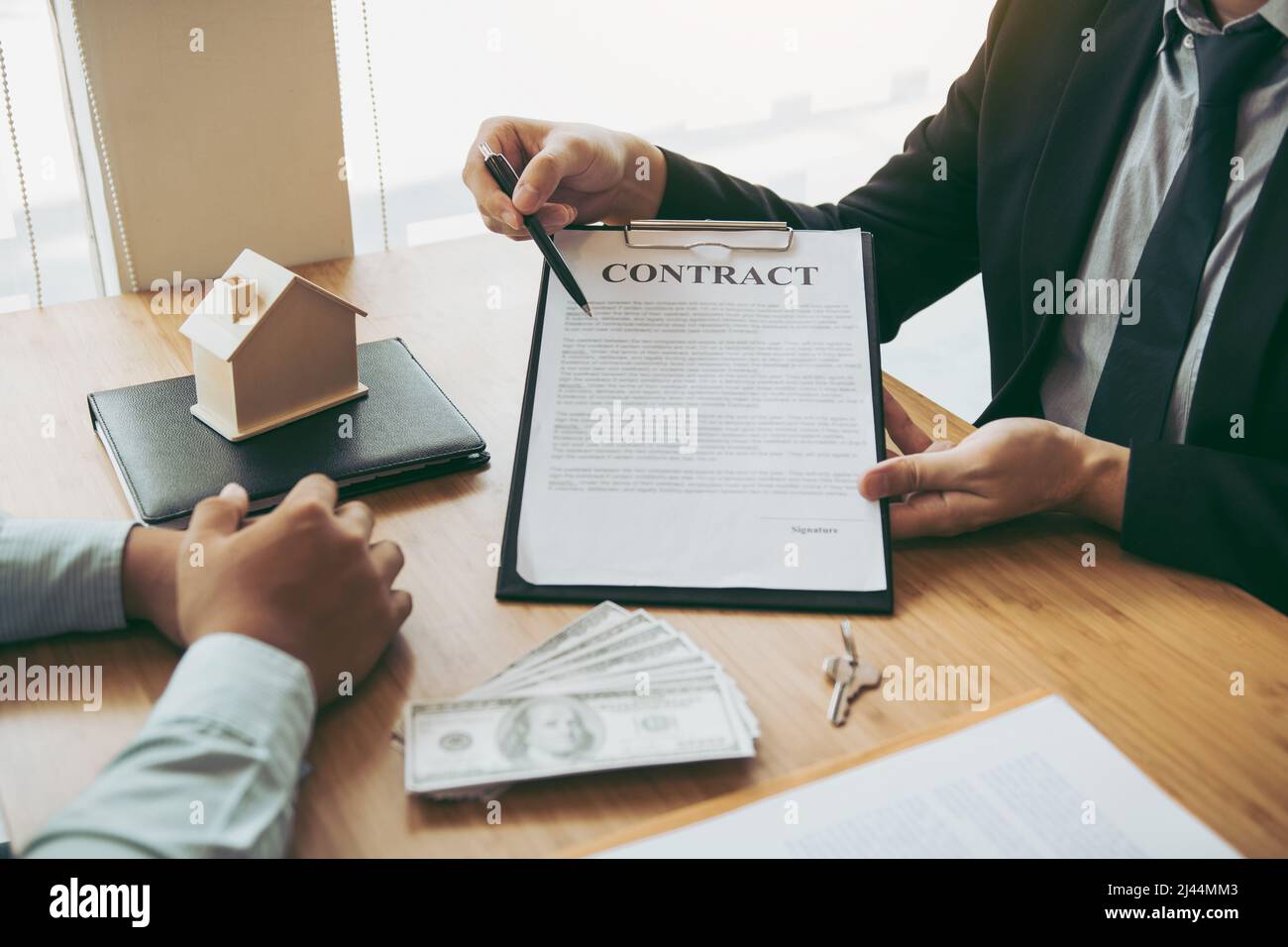 Agents are using pens pointing to insurance contracts and are being explained to customers at ...