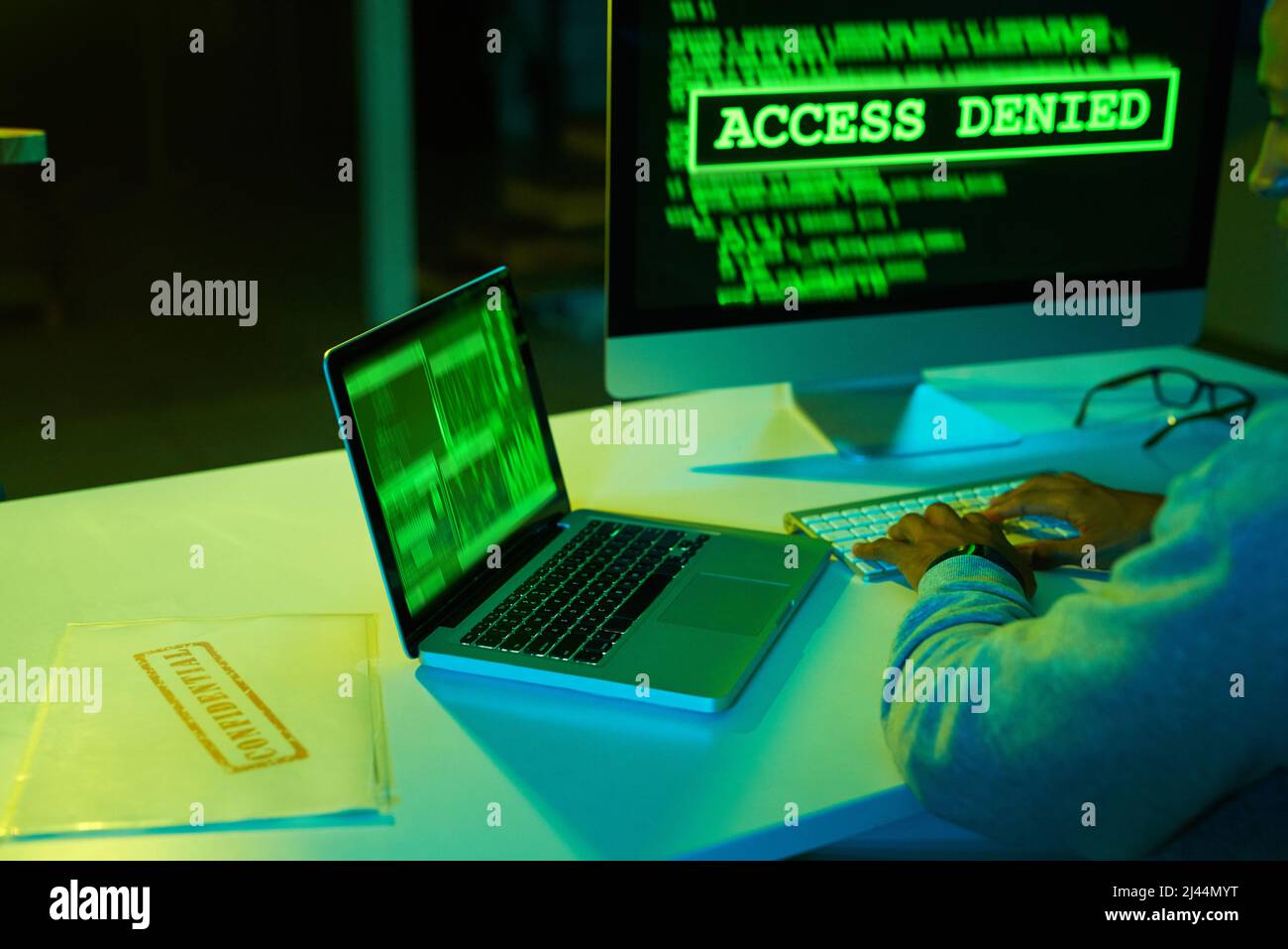 Your secret files arent safe from me. Shot of an unrecognizable hacker ...