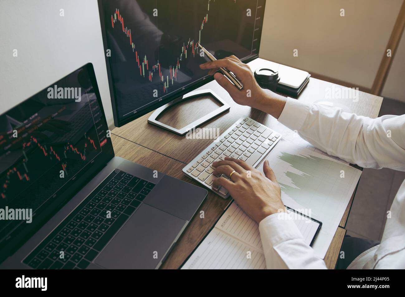 Close up of hand investors are pointing to laptop computer that have investment information ...