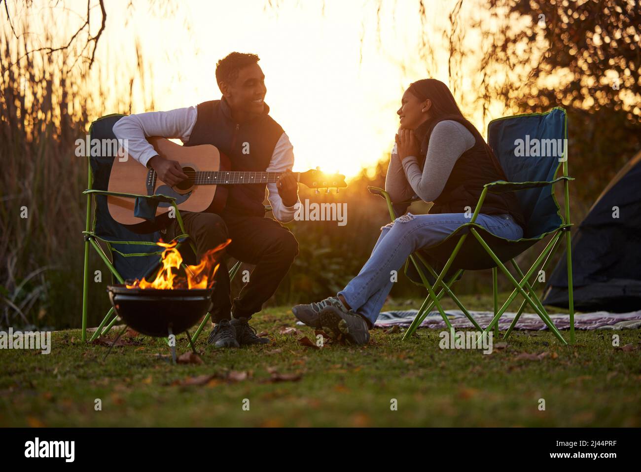 I wrote this for you. Shot of a young man serenading his girl while ...