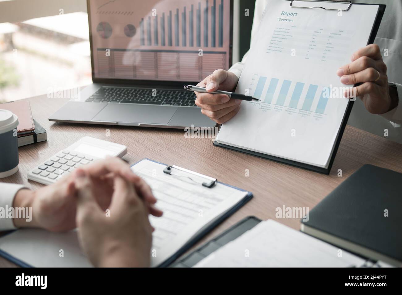 Business employee man are reporting about performance graphs summary ...