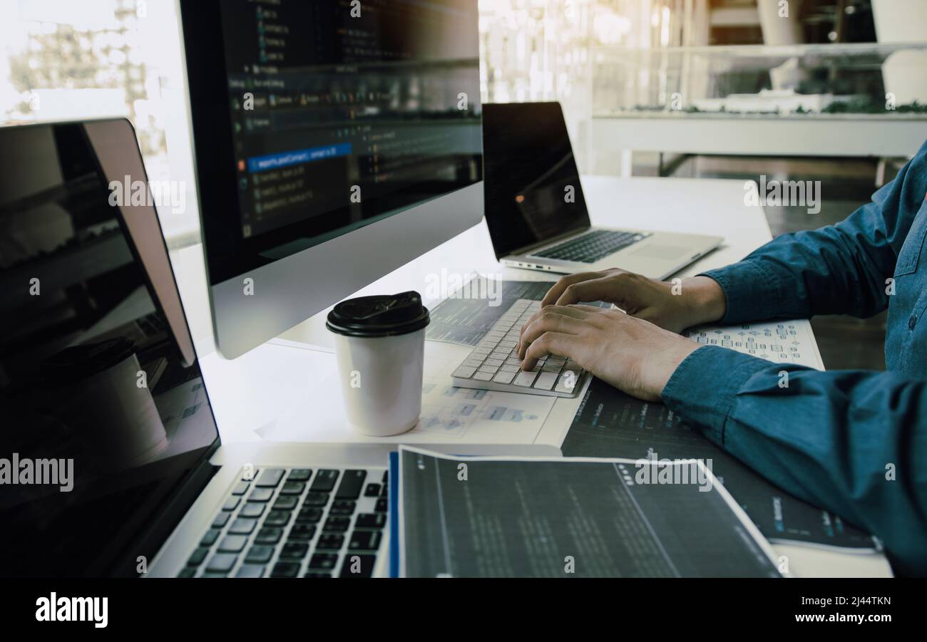 Asian man working code program developer computer web development working design software on ...