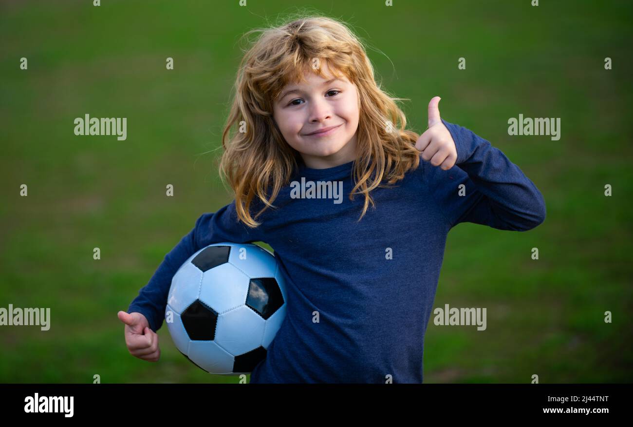 Young soccer player in sportswear with soccer ball show thumbs up ...