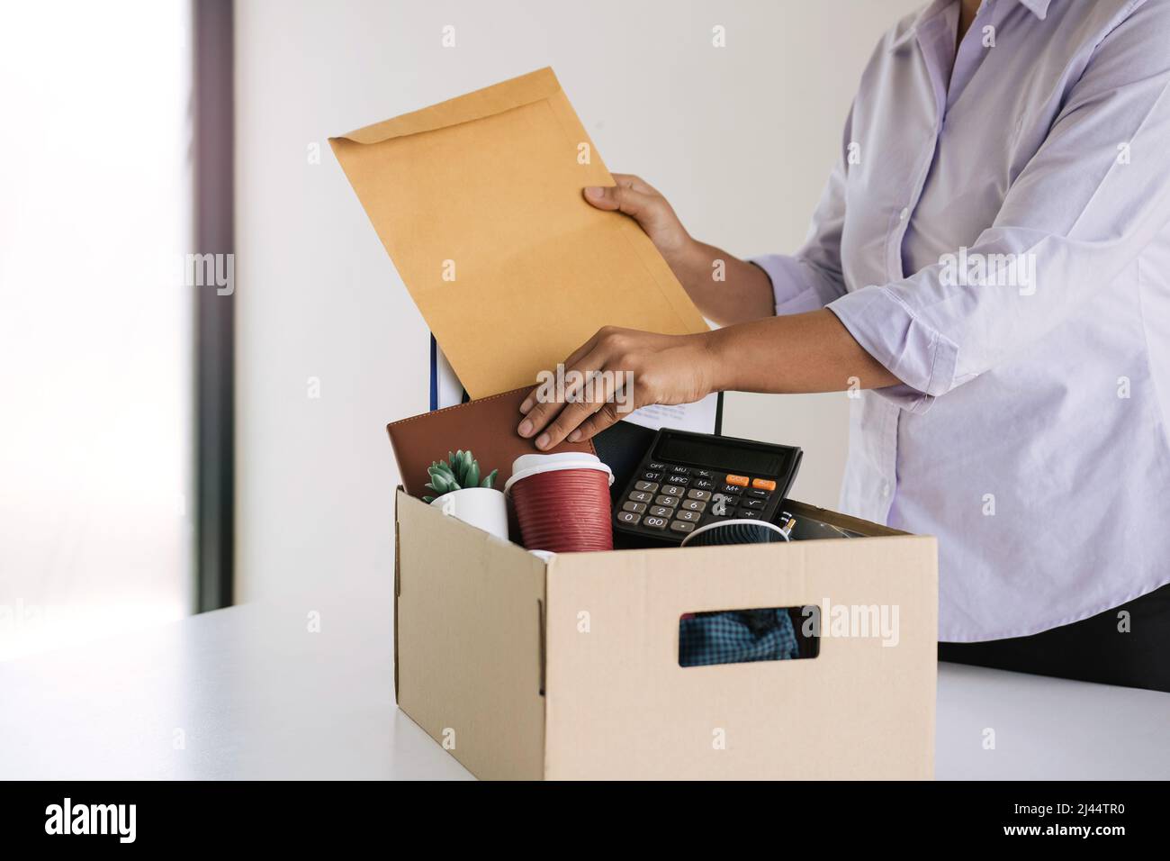 Woman employees are keeping their own items on the desk because they ...