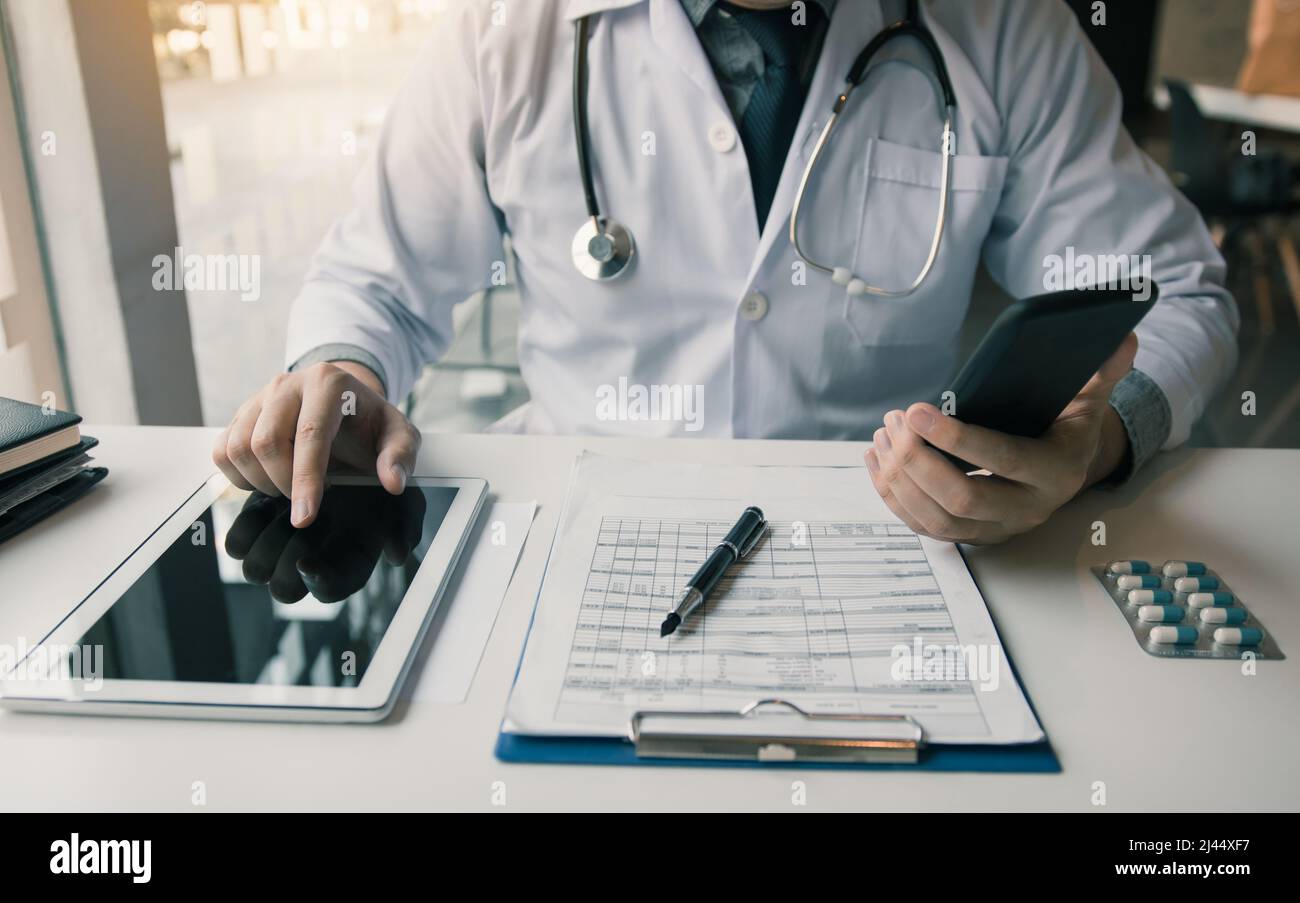 Asian doctor using the tablet explaining the patient condition and the ...