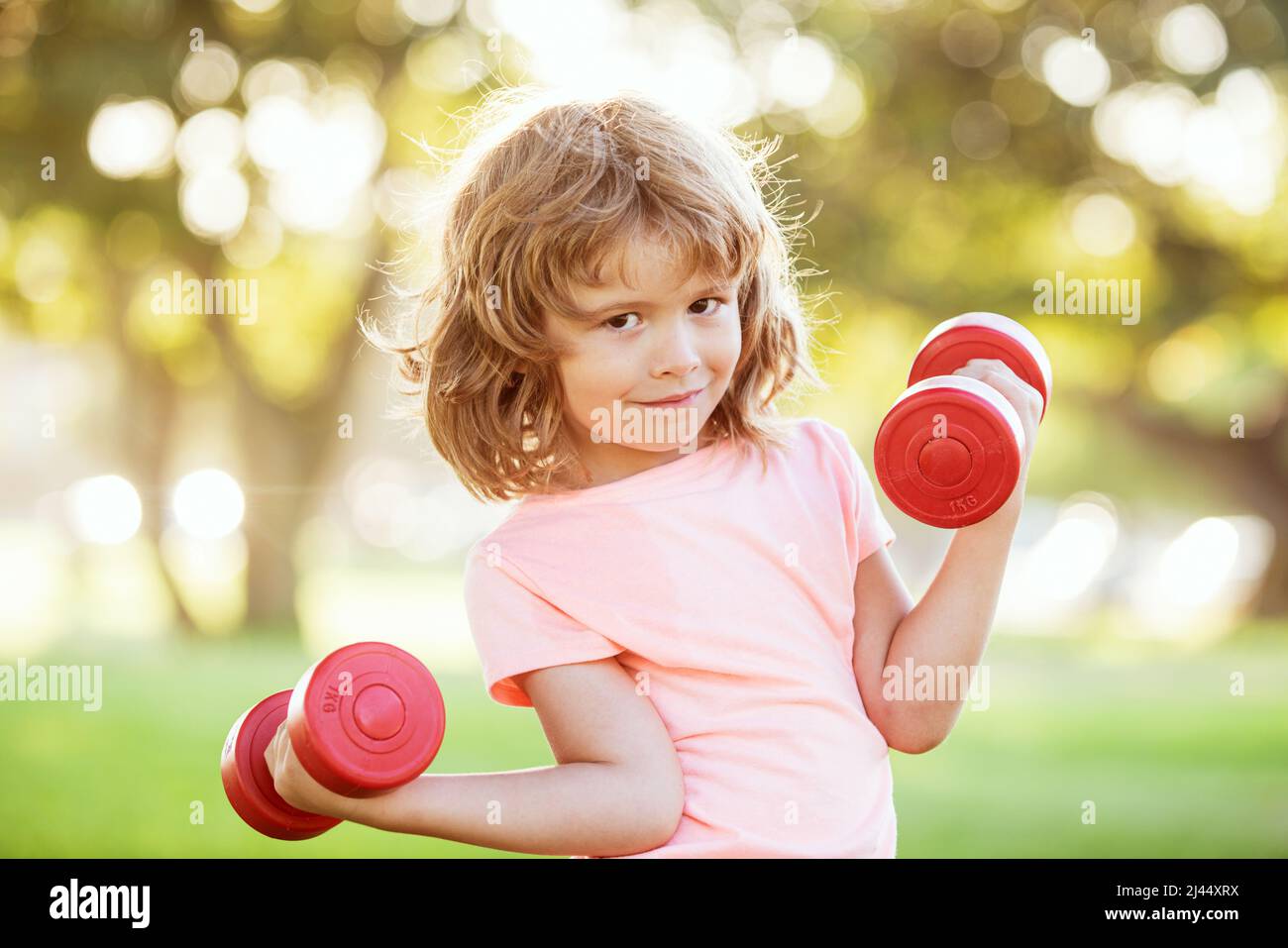 Sporty cute child with dumbbells. Kids sport and fitness, health and ...