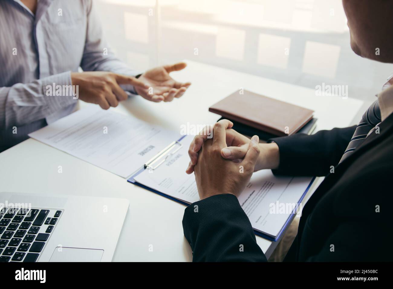 Male employee is explaining to the manager while being interviewed in ...