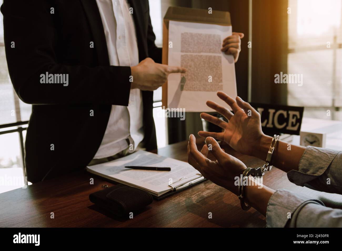 The police officer pointed to the document requesting the arrest of the ...
