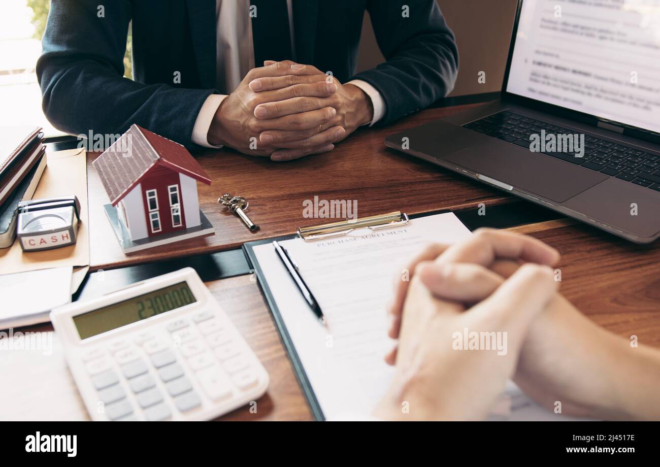 House sales representative sat at the office with the new home buyer ...
