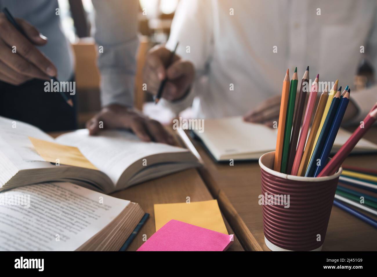 Teenage student works on homework in his room and writing in notebook ...
