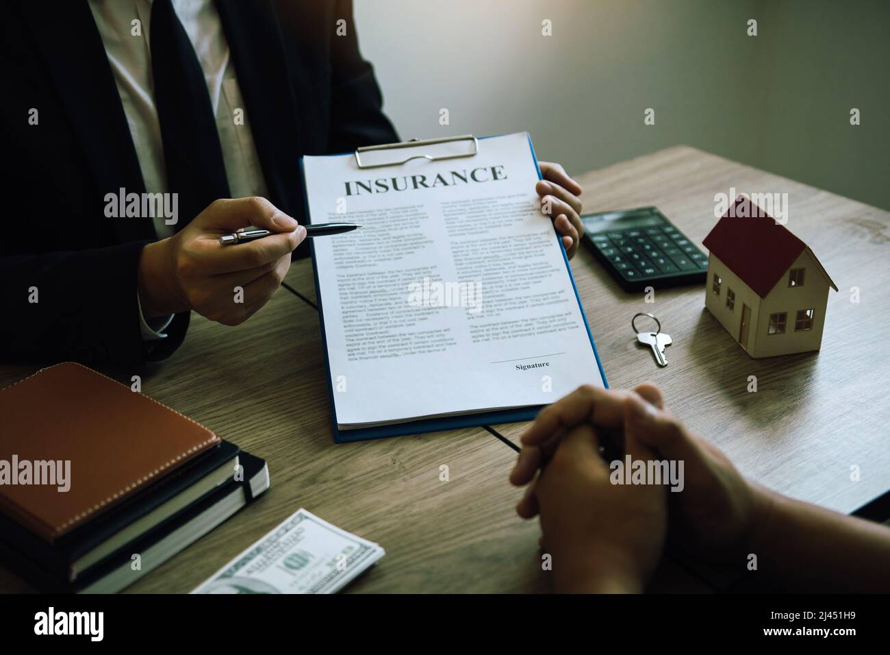 Agents are using pens pointing to insurance contracts and are being ...