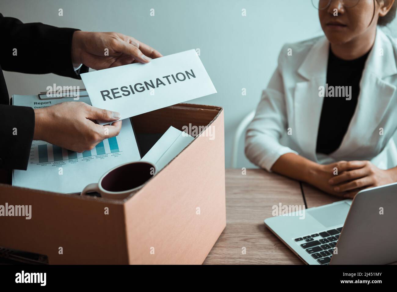 Male employee takes the handle to the resignation envelope while being ...