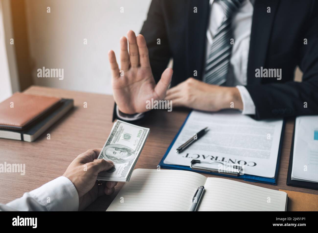 Business person refusing bribe given money by partner with anti bribery ...