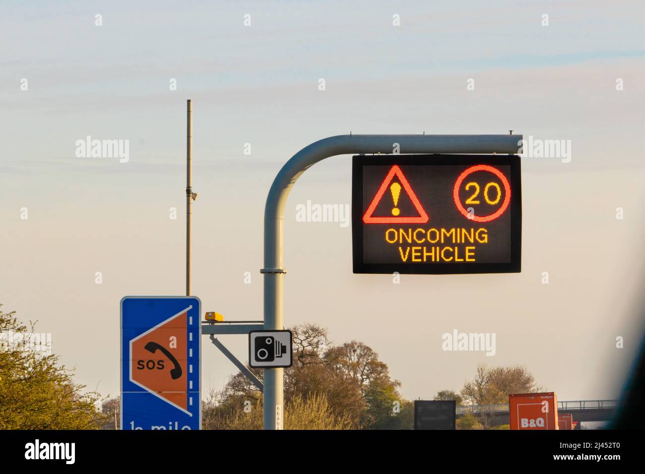 warning matrix sign on gantry with "oncoming vehicle "and 20 mph speed ...