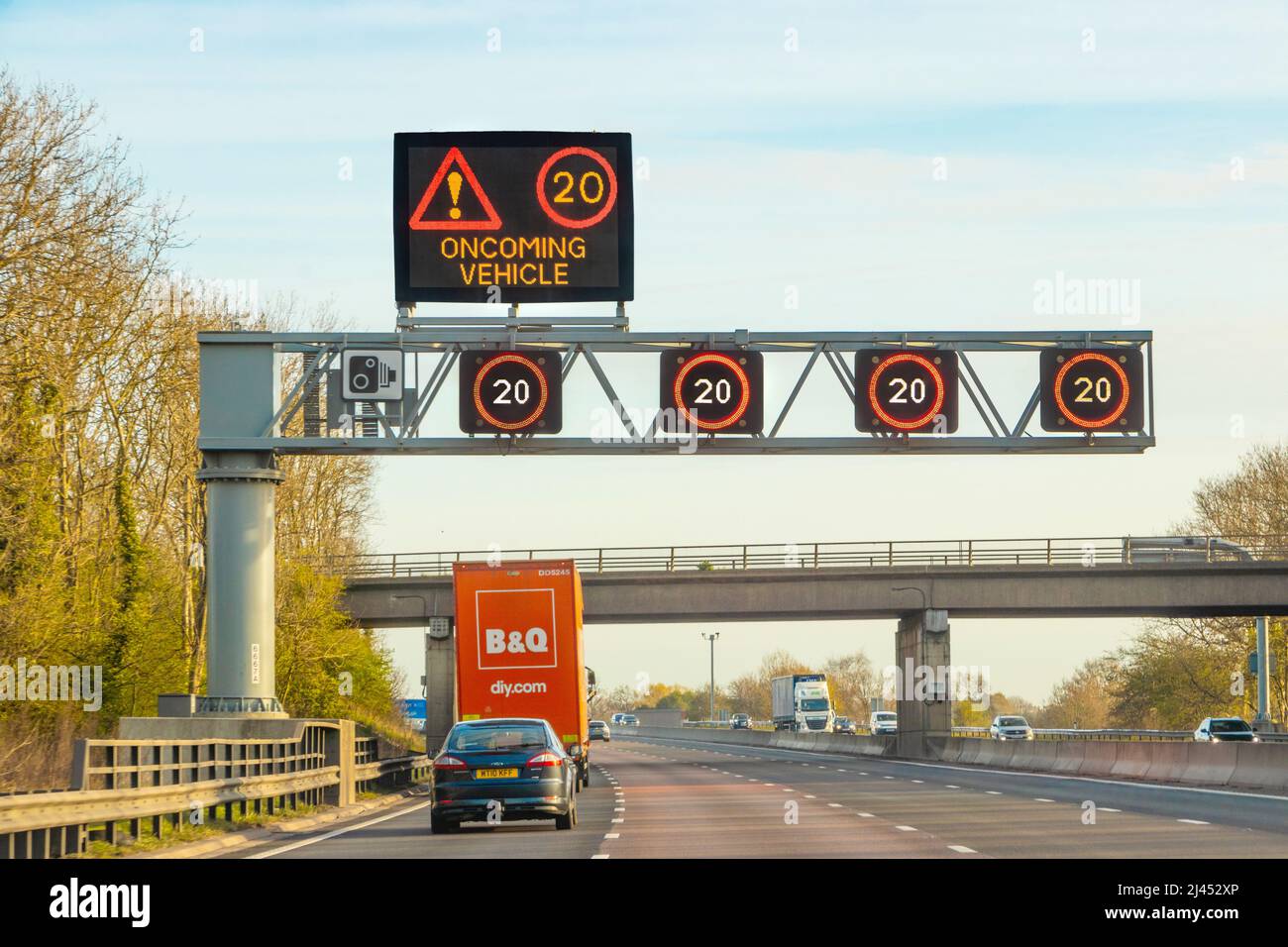 warning matrix sign on gantry with "oncoming vehicle "and 20 mph speed ...