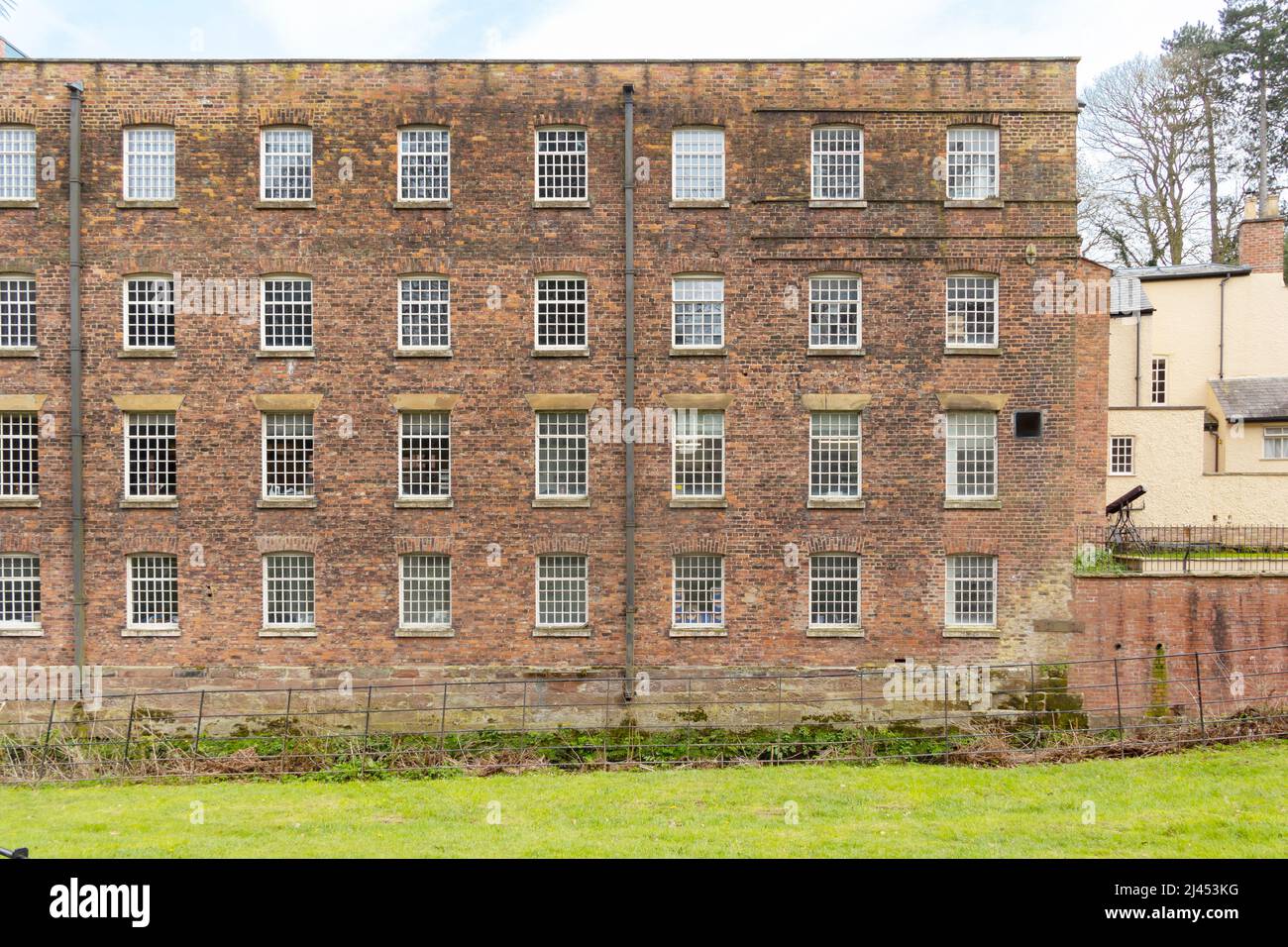 Dunham Massey red brick textile mill building and chimney Stock Photo ...