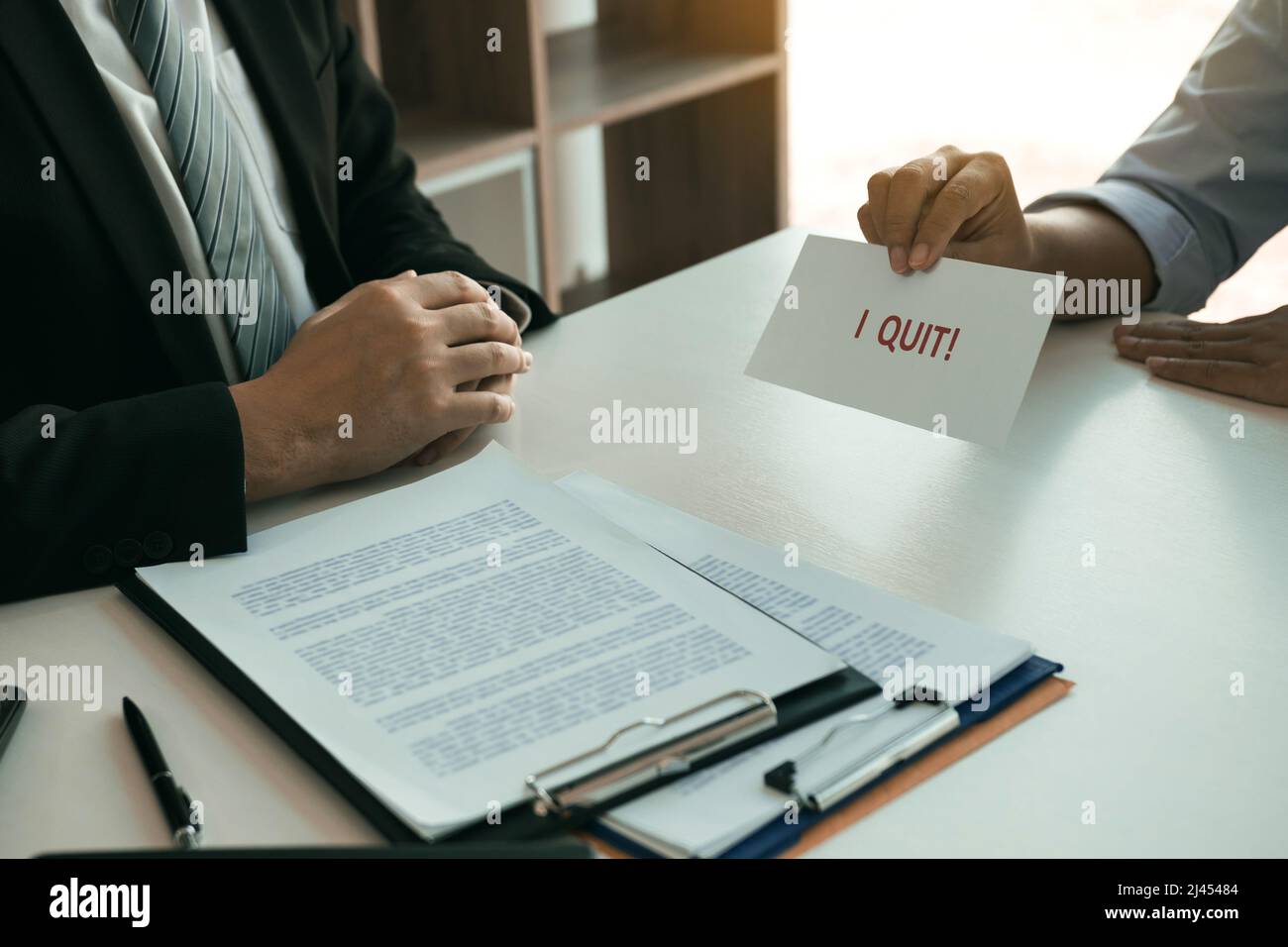 Female employee is submitting an envelope requesting a resignation from ...