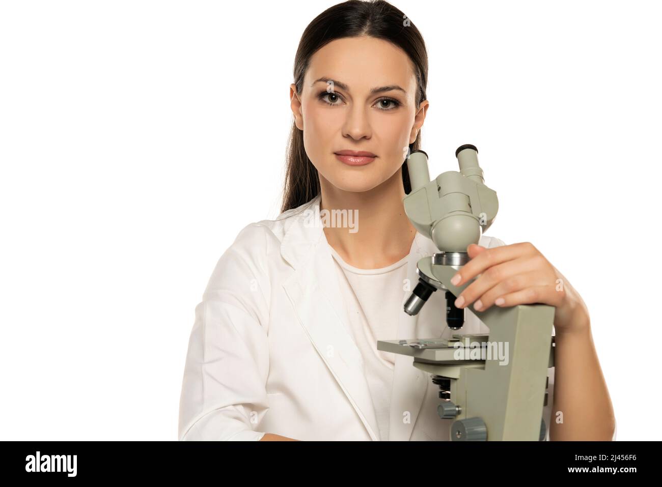 Portrait of female scientist with microscope on a white background ...