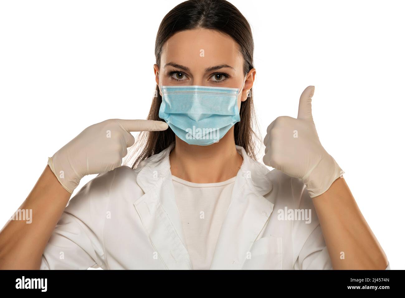 Beautiful female doctor or nurse wearing protective mask and latex or ...