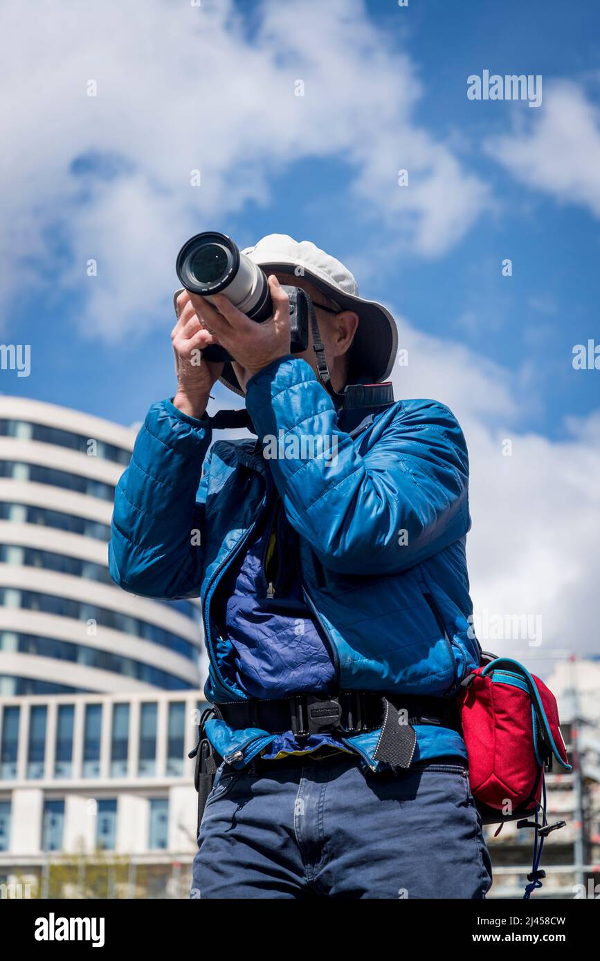 Photographer at work, photographing a demonstration in central London ...